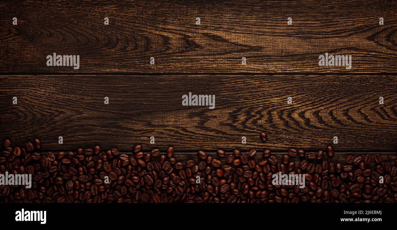 Line coffee background. Roasted dark brown grains scattered on wooden ...