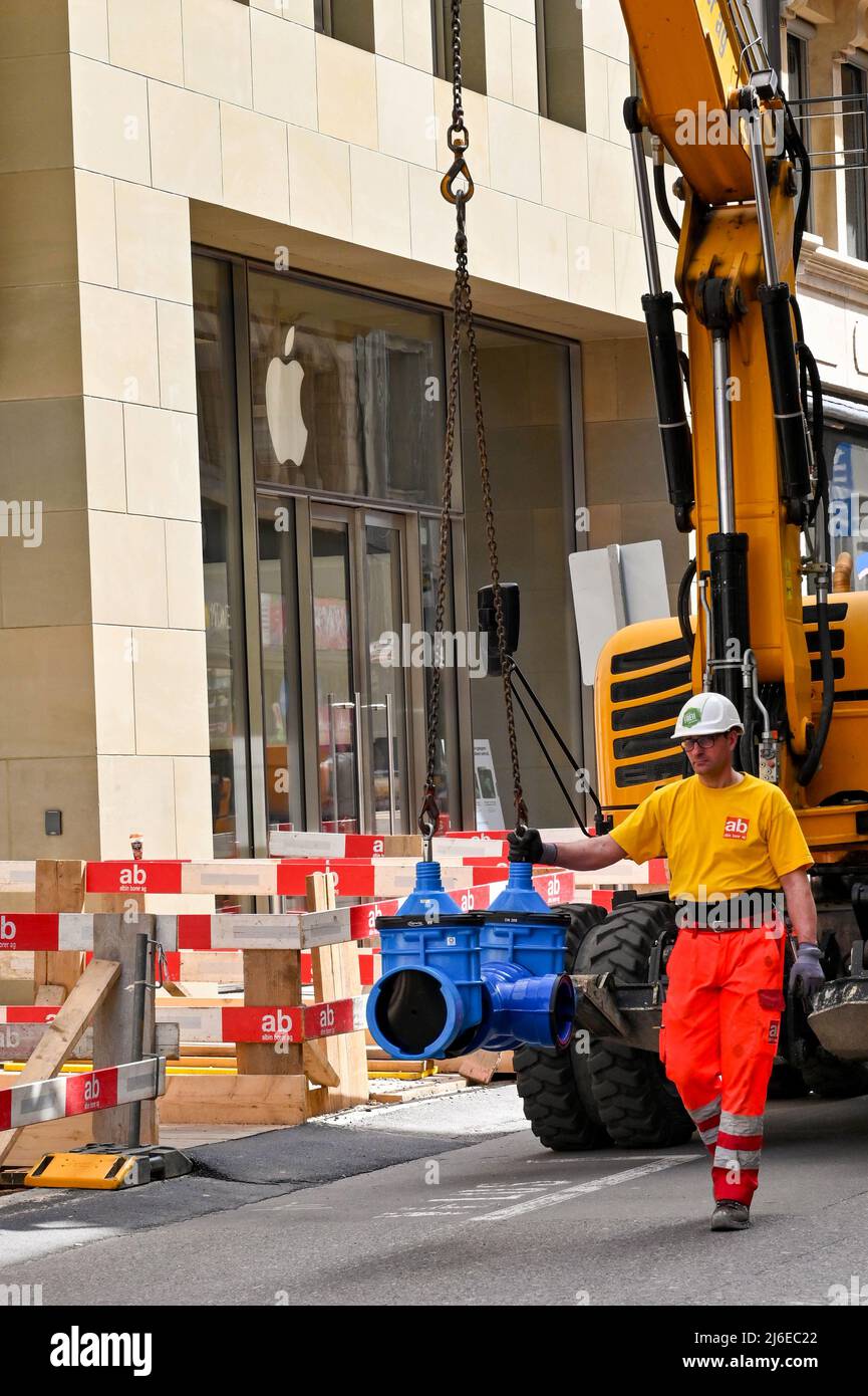 Basel, Switzerland - April 2022: Construction worker moving a heavy ...