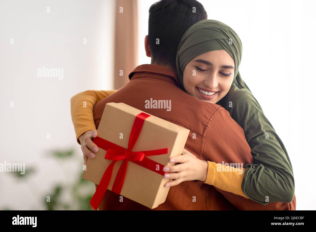 Muslim man holding gift box hi-res stock photography and images - Alamy