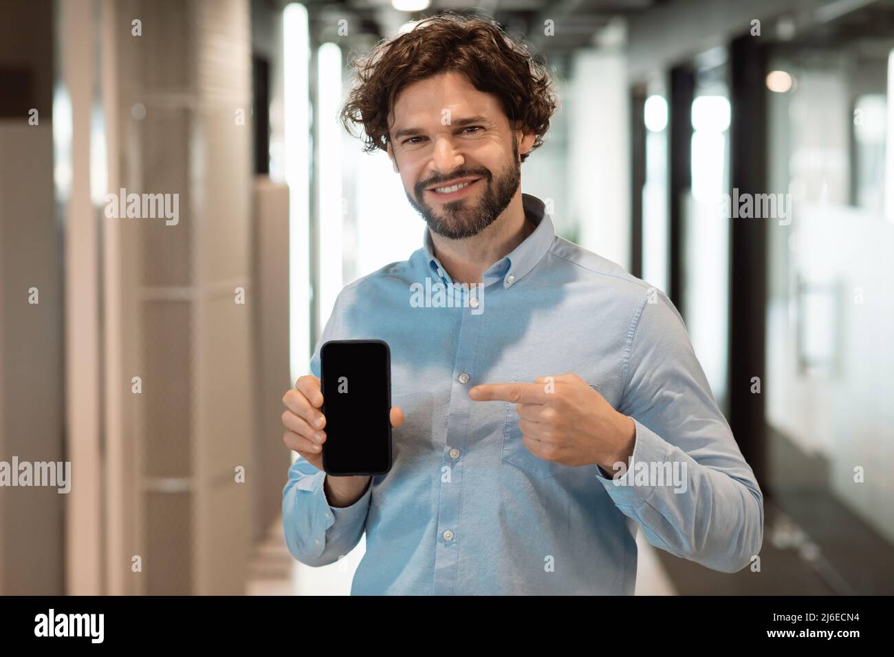 Businessman pointing at black empty smartphone screen Stock Photo - Alamy