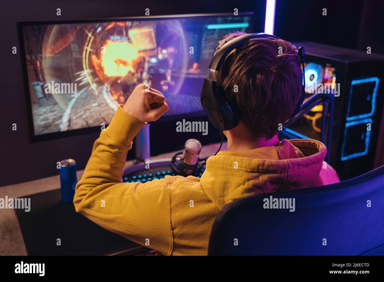 Pro gamer wearing headphones celebrating his winning in online esport ...