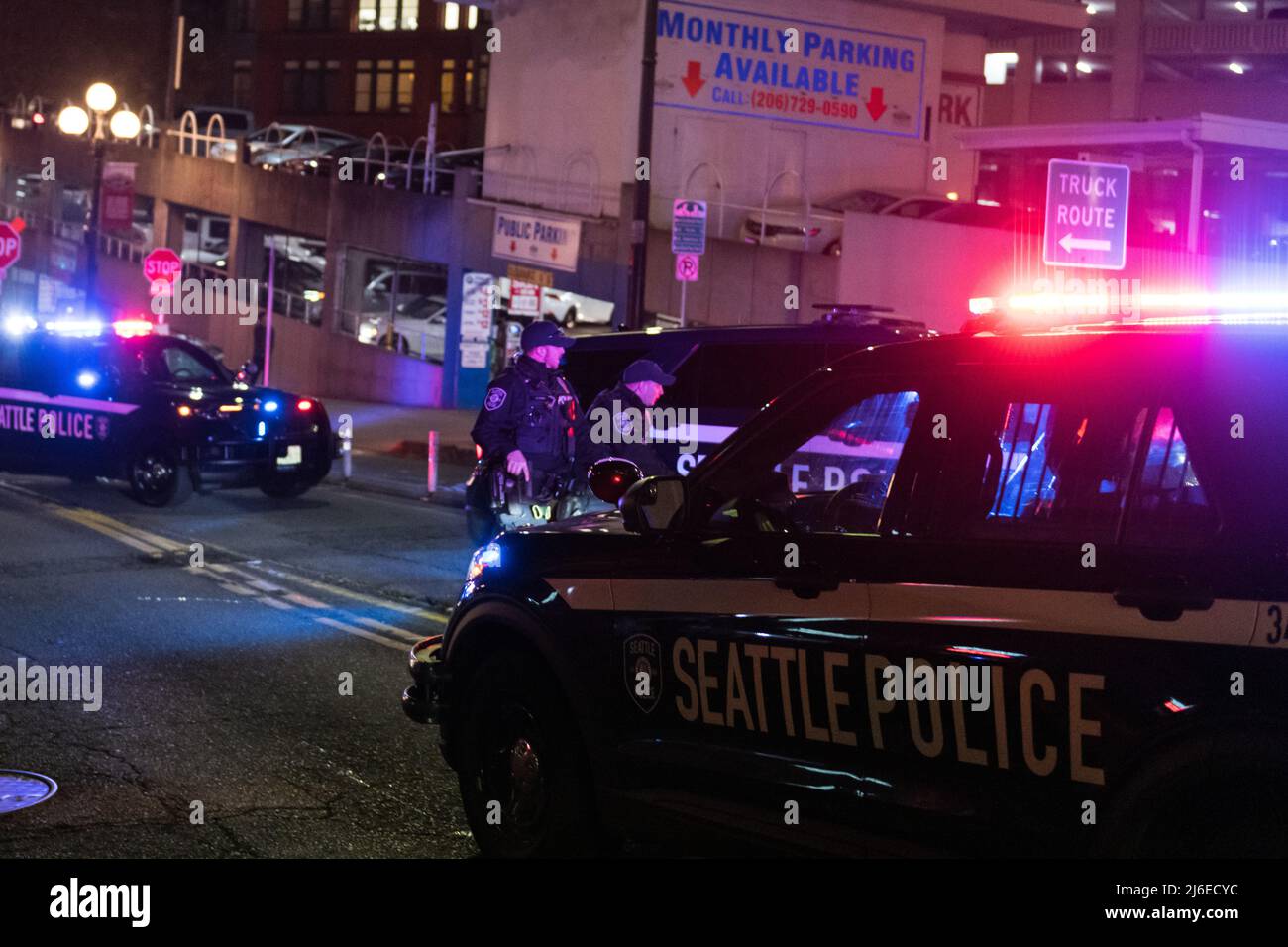 Seattle, USA. 1st May, 2022. Police taking cover behind their car at ...