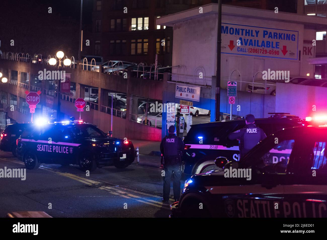 Seattle, USA. 1st May, 2022. Police taking cover behind their car at ...