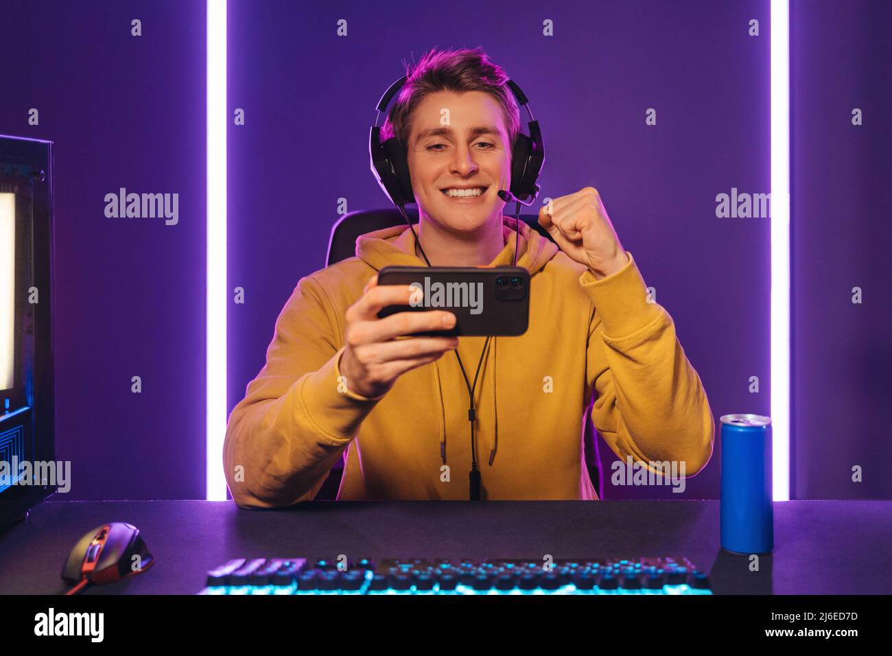 Pro gamer wearing headphones celebrating his winning in online mobile ...