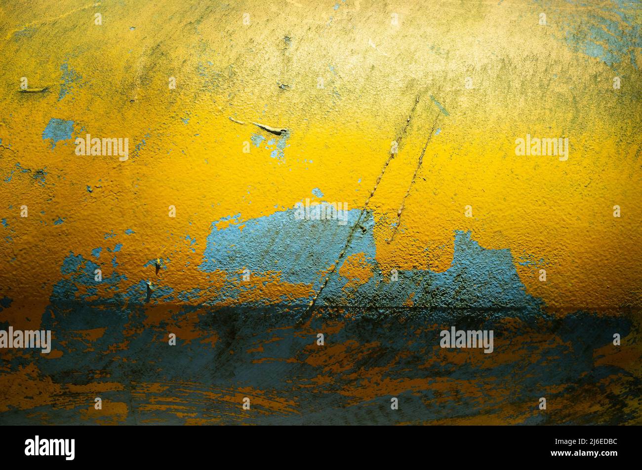 Old wall with scratched peeling blue-yellow paint. Textured background ...