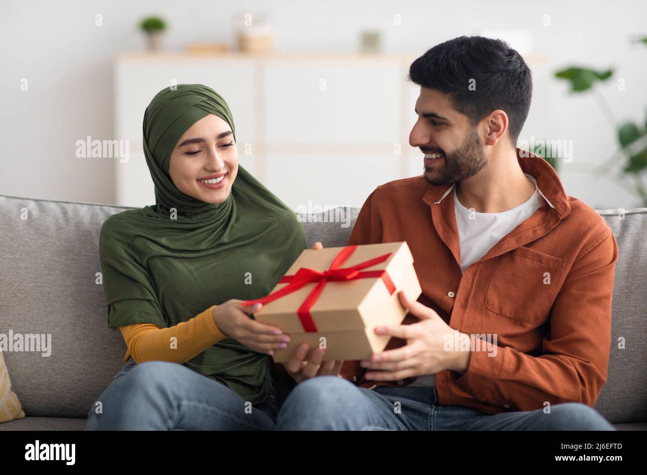 Happy Muslim Man Giving Gift To Wife Celebrating Holiday Indoor Stock ...