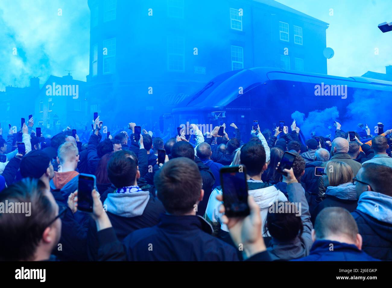 The Everton team bus arrives as fans let off blue flares Stock Photo ...