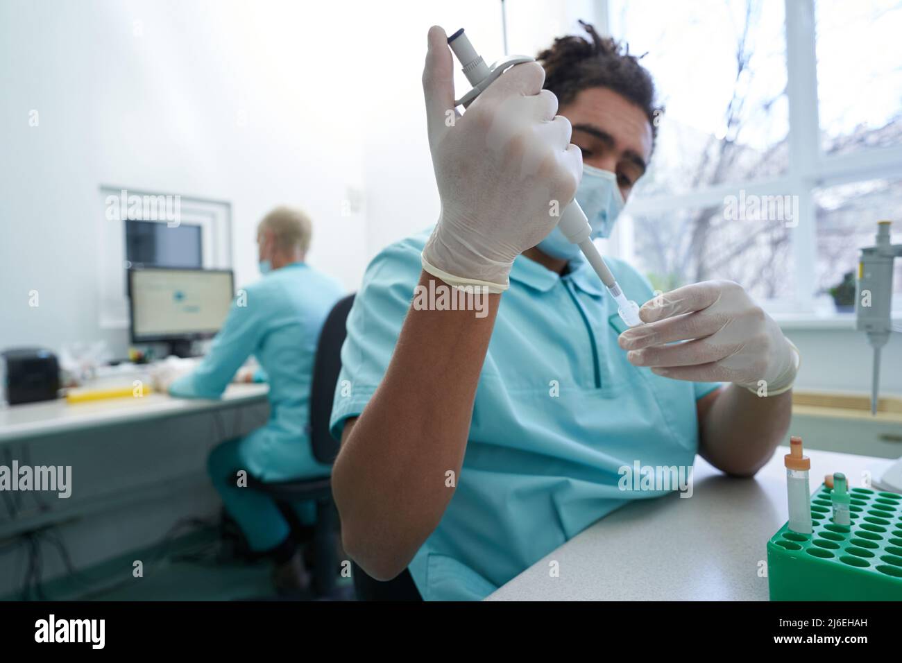 Man doing medical tests in laboratory with collegue Stock Photo - Alamy