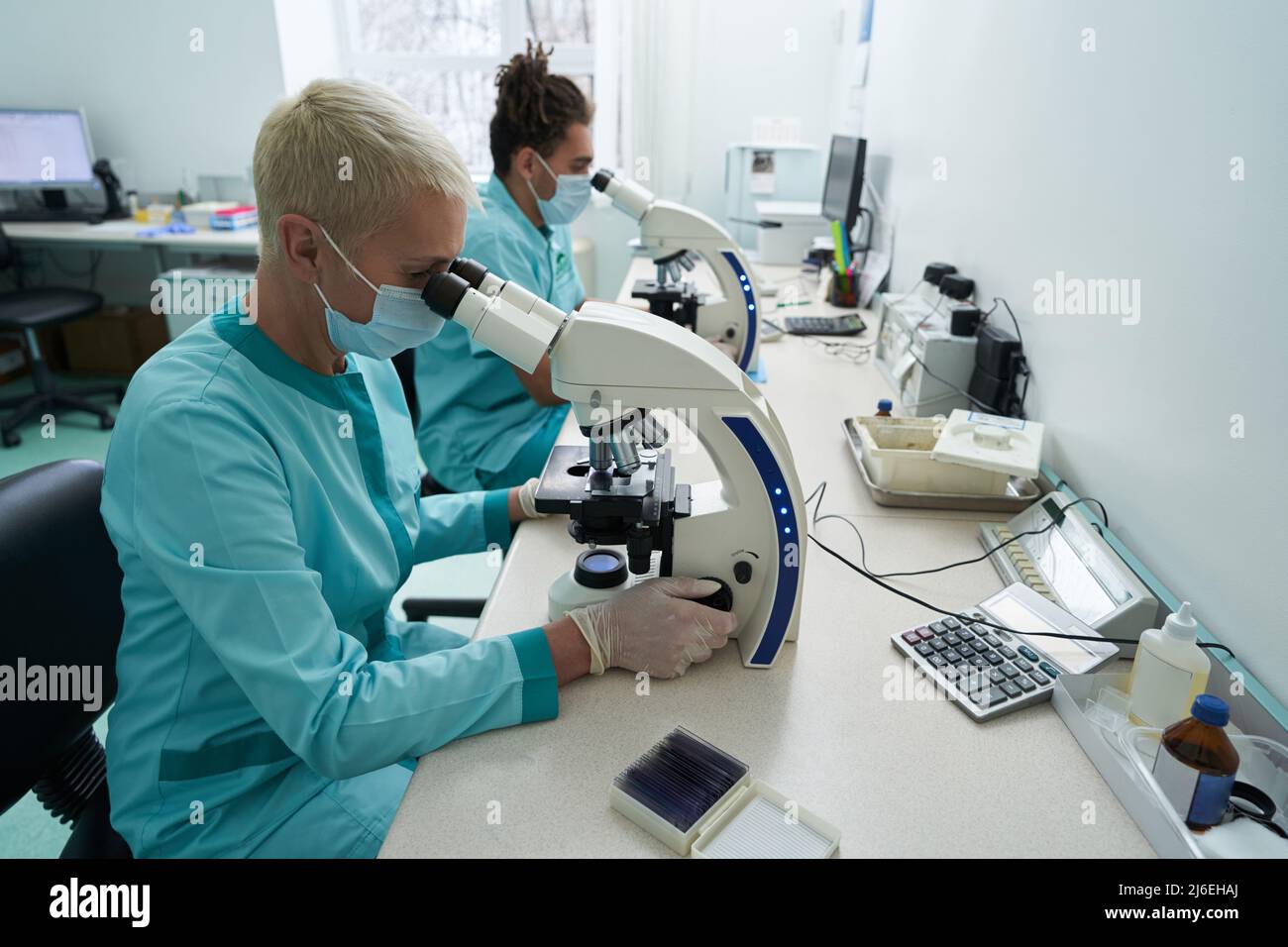 Two medical professionals doing blood tests in laboratory Stock Photo ...