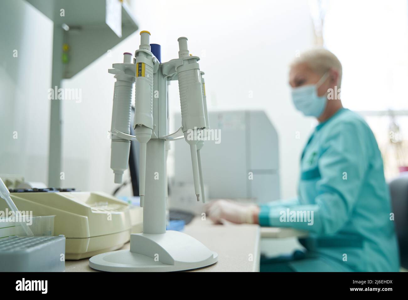 Female laborant working in office with modern medical equipment Stock ...
