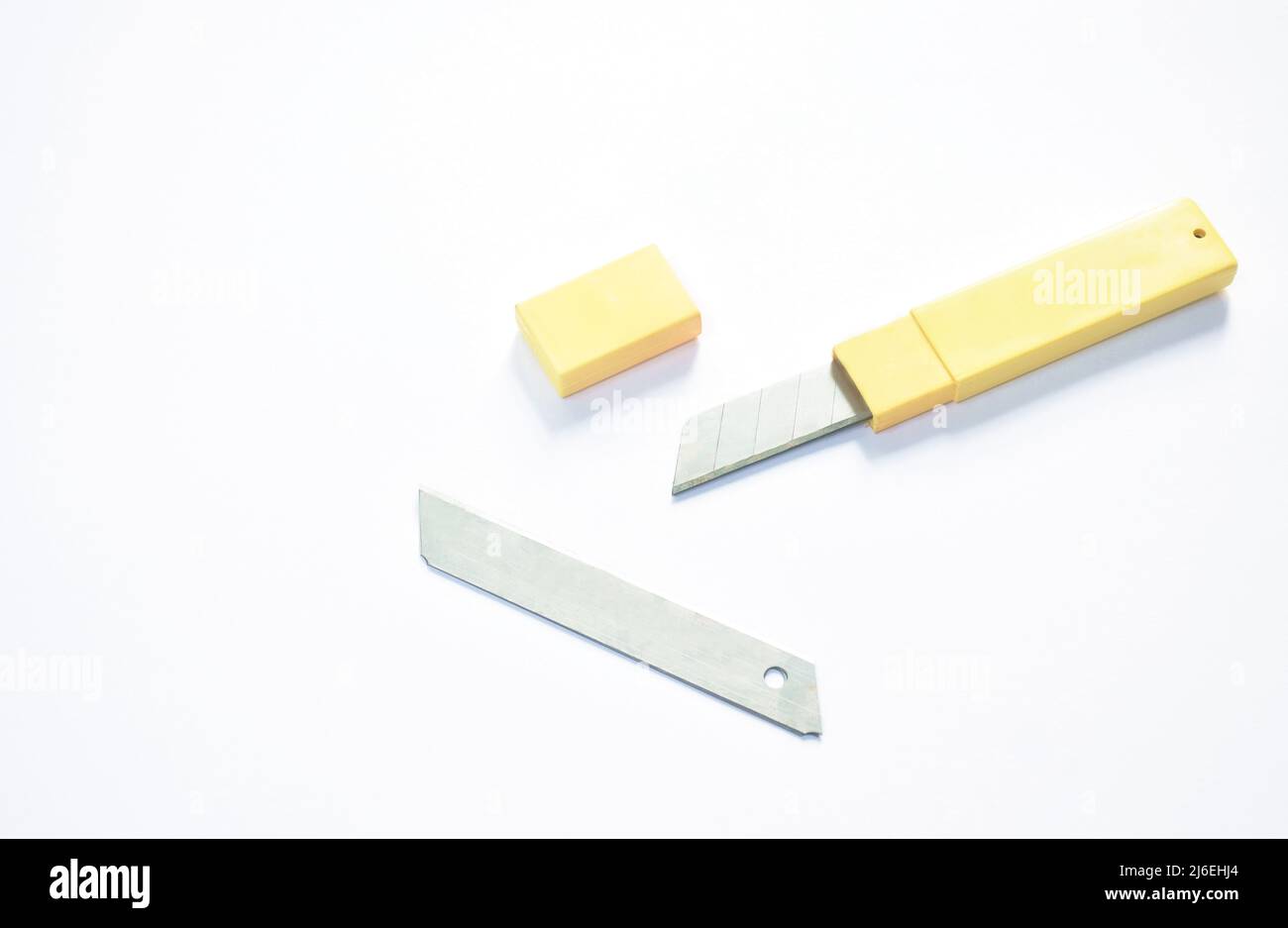 cutter blade in yellow box package on white background Stock Photo - Alamy