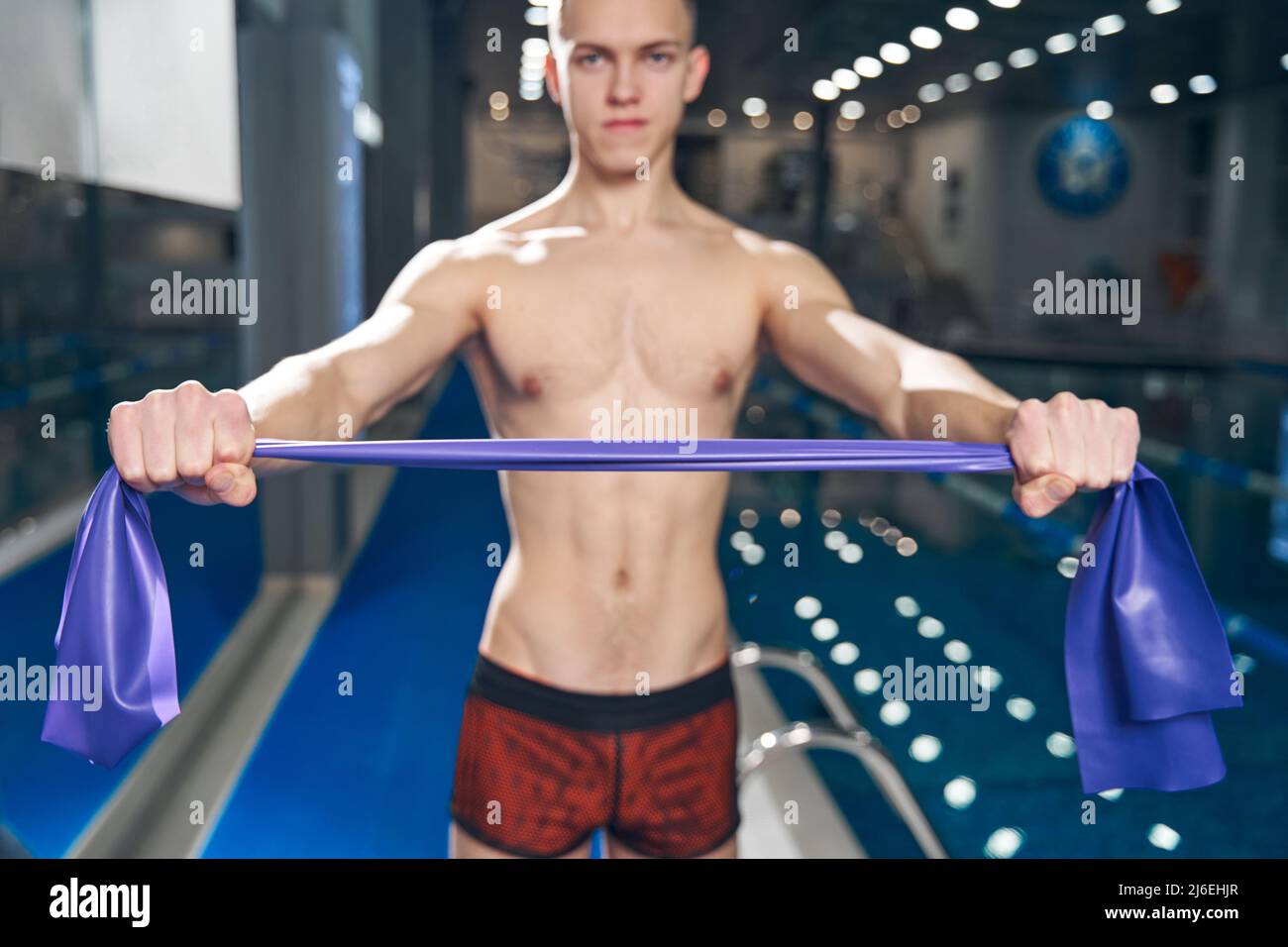Young caucasian athletic man pulling resistance band by his hands Stock ...