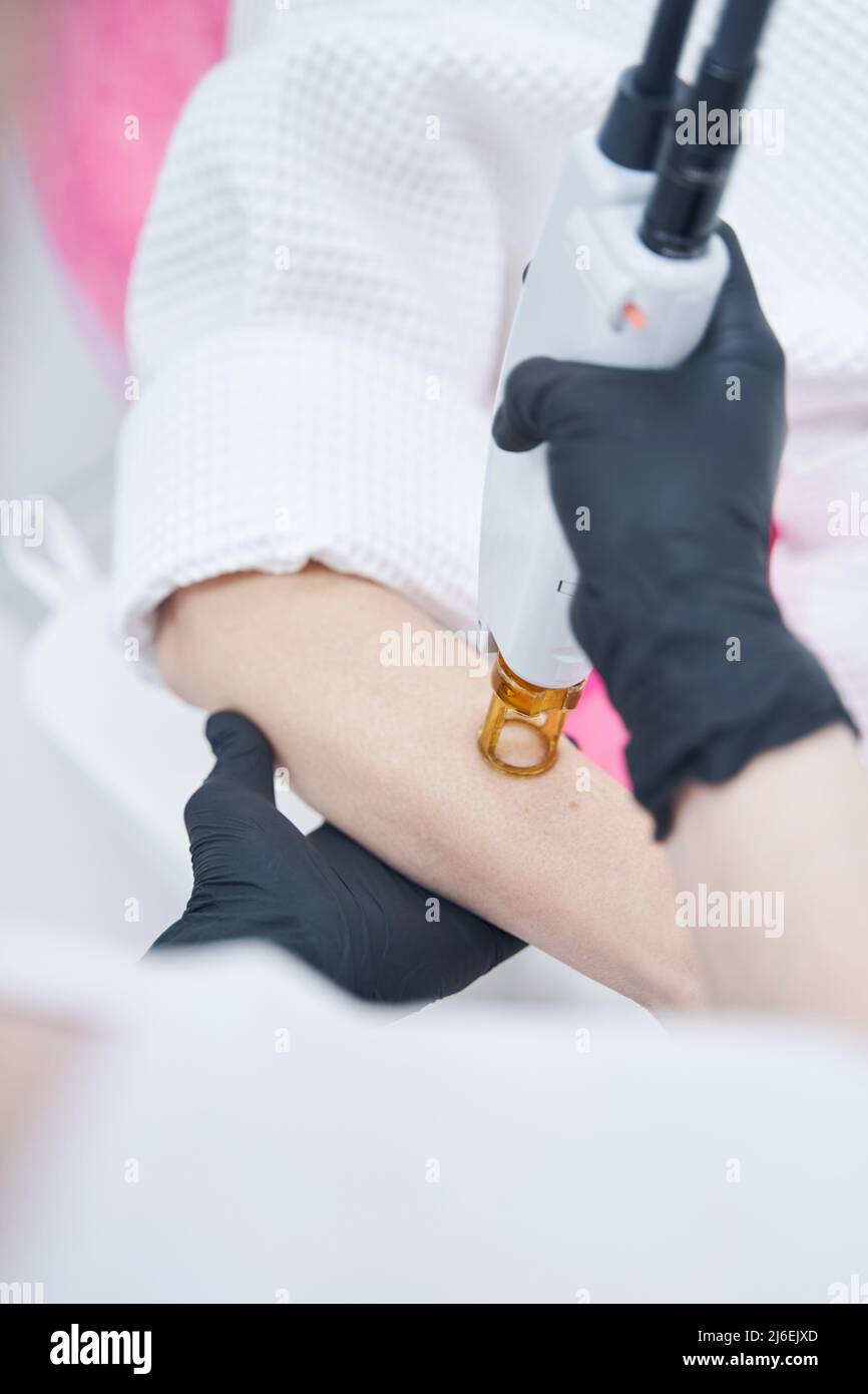 Woman performing aesthetic treatment hi-res stock photography and ...