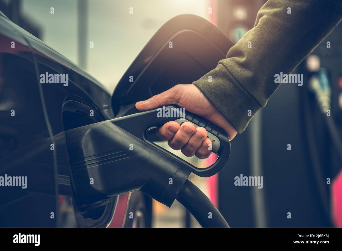 Caucasian Men Charging His EV Electric Vehicle at Charging Station ...