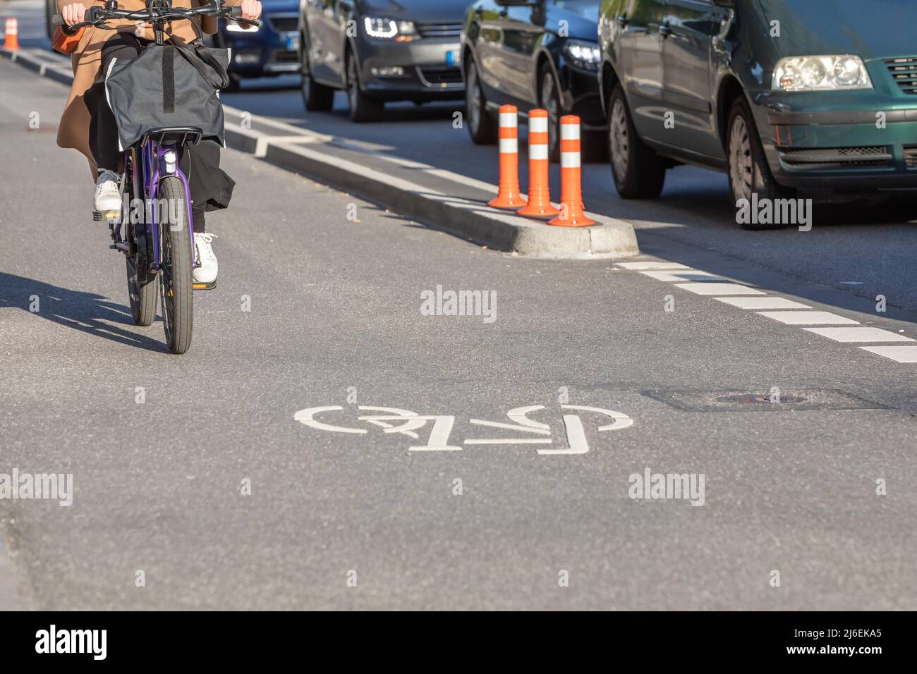 bicycle on a bike lane protected by curbs Stock Photo - Alamy