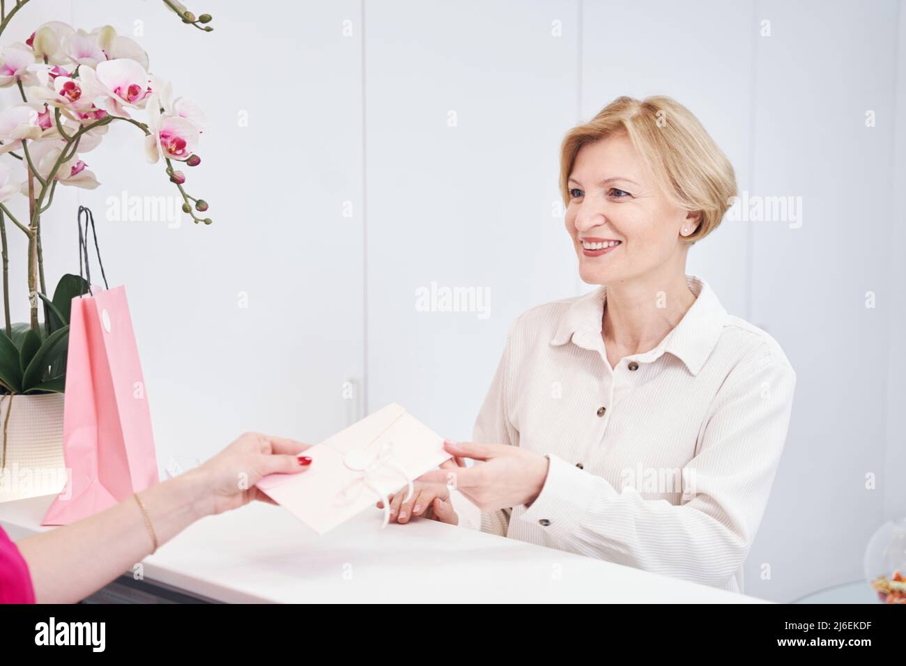 Happy client visiting clinic of aesthetic medicine Stock Photo - Alamy