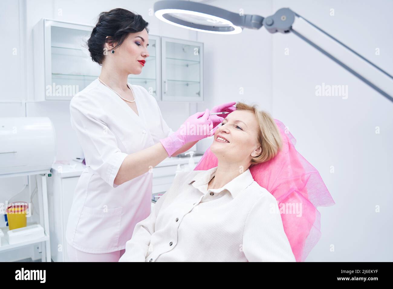 Positive delighted senior woman doing lifting procedure Stock Photo - Alamy