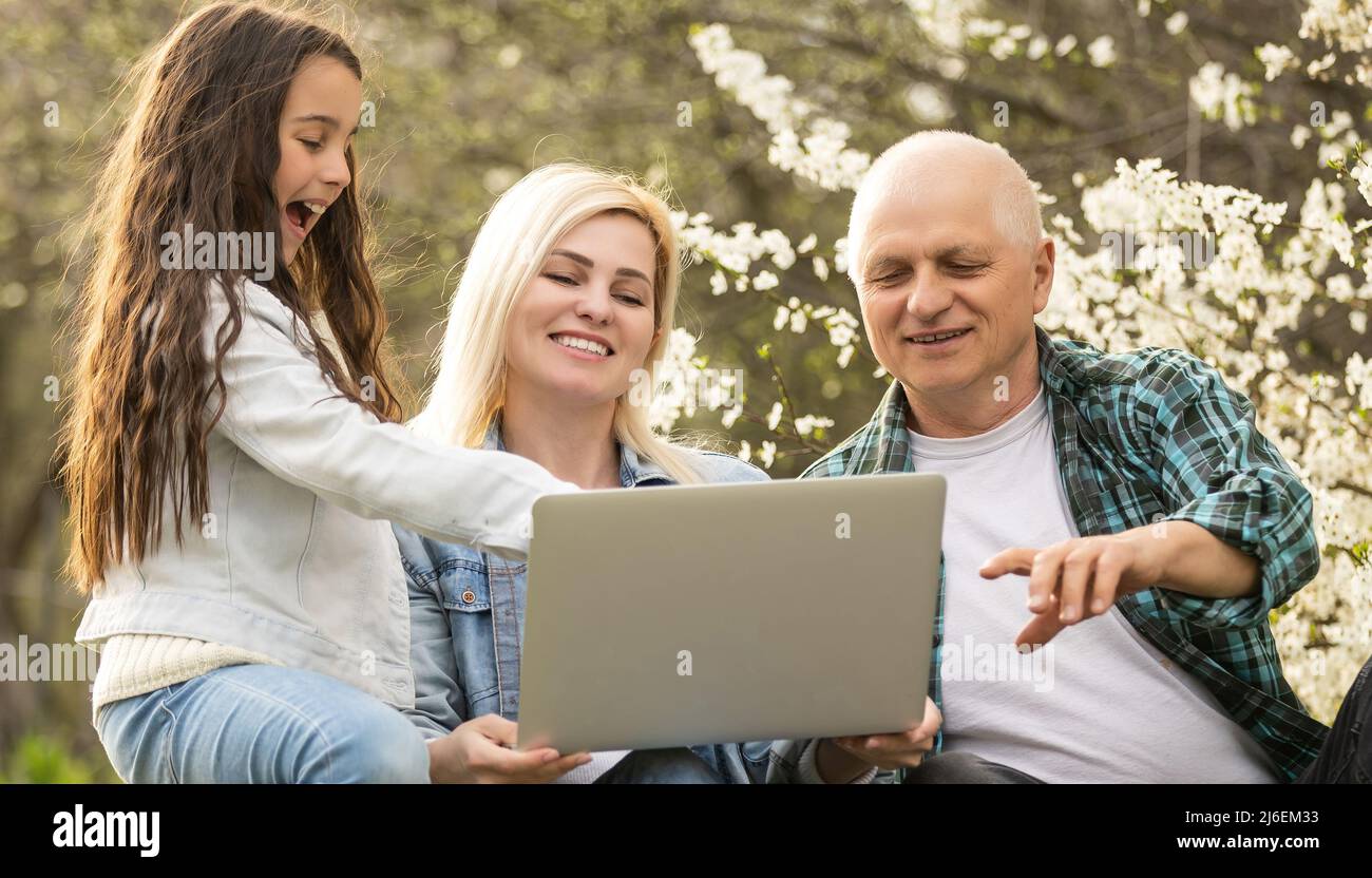 Generation Family On Grass Together in the garden Stock Photo - Alamy