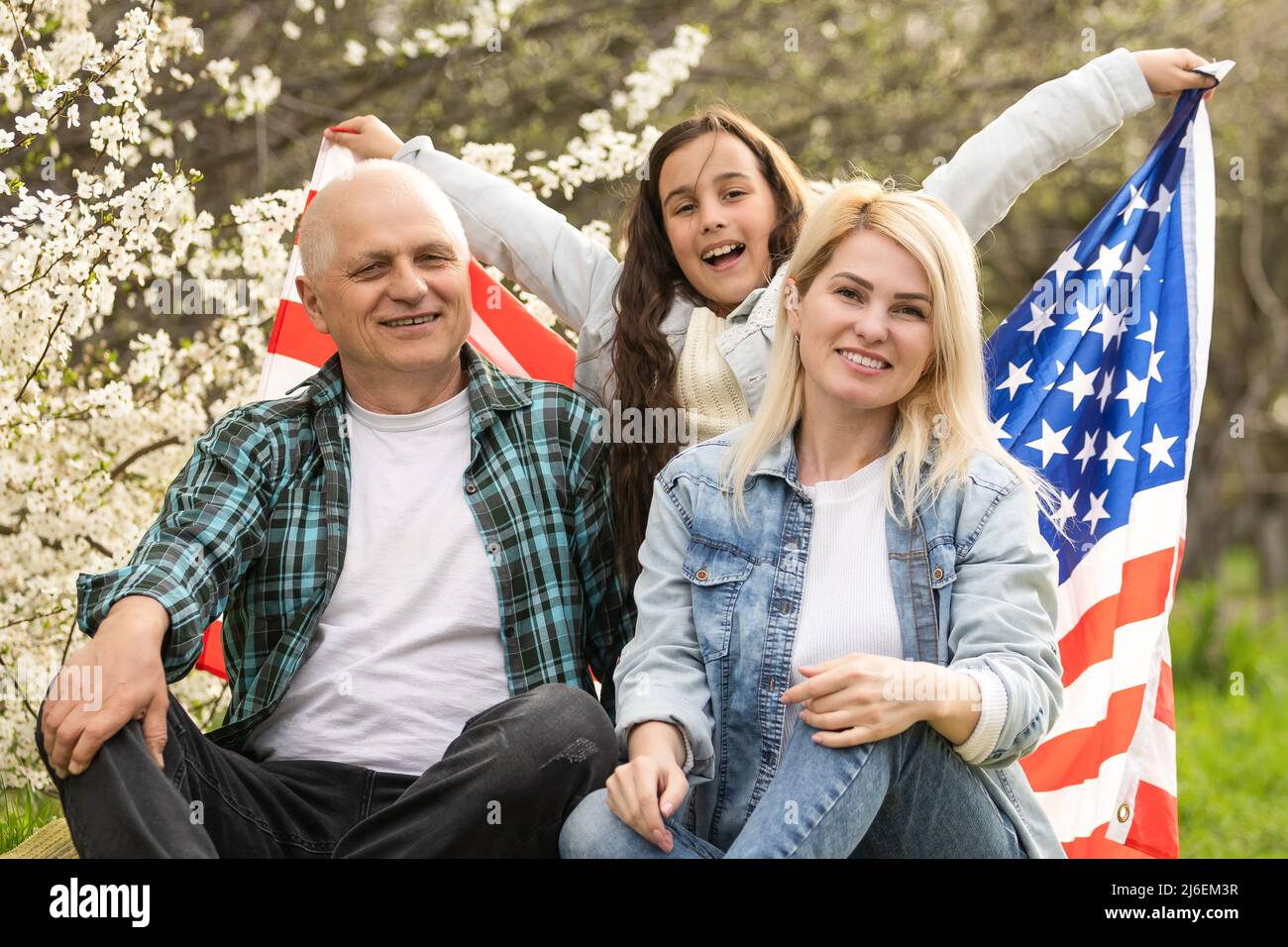 american family with USA flag outdoors Stock Photo - Alamy