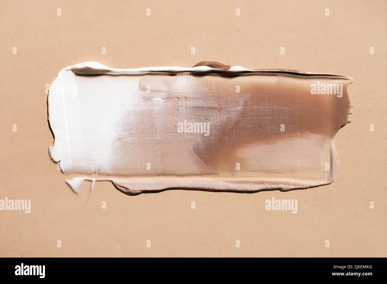 White cream texture on a pastel beige background. Cosmetic mask balm ...