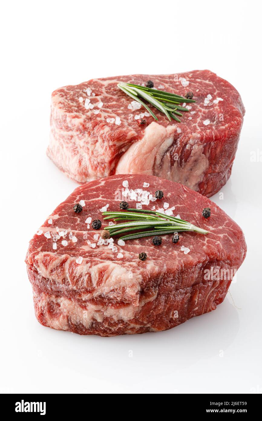 Raw juicy filet mignon steak with seasoning isolated on white Stock ...