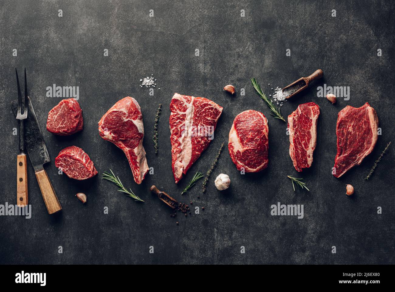 Various types of raw pork meat and beef on black board Stock Photo - Alamy