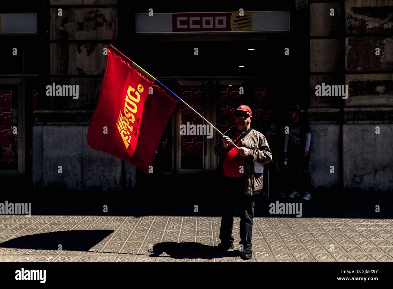 Barcelona, Spain. 1st May, 2022. A demonstrator waves his unions flag ...