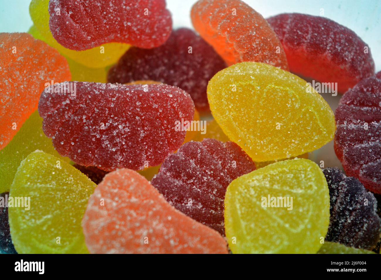Multi-colored sweets in the form of fruits of different colors: red ...