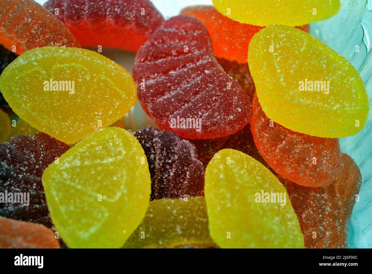 Multi-colored sweets in the form of fruits of different colors: red ...