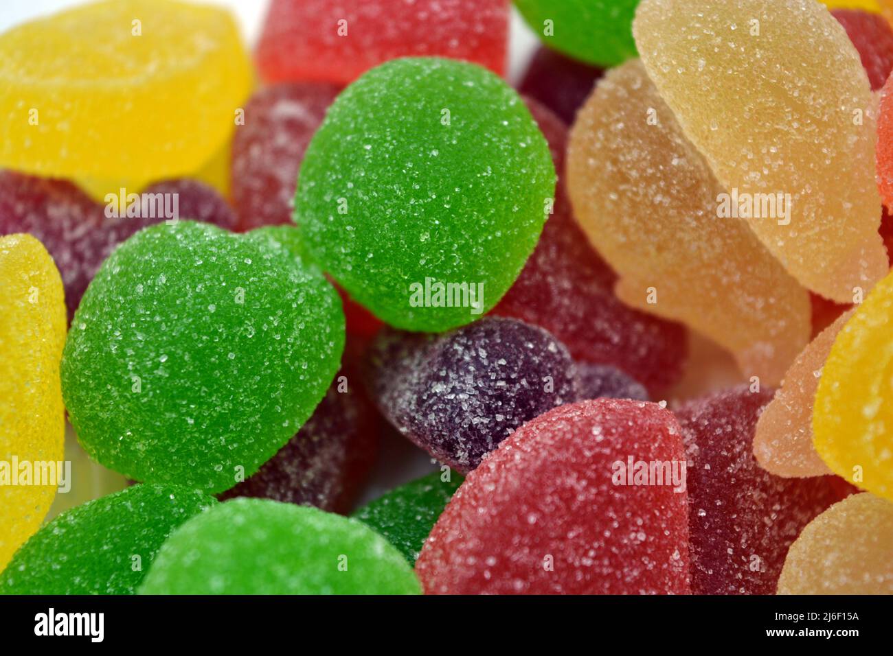 Multi-colored sweets in the form of fruits of different colors: red ...