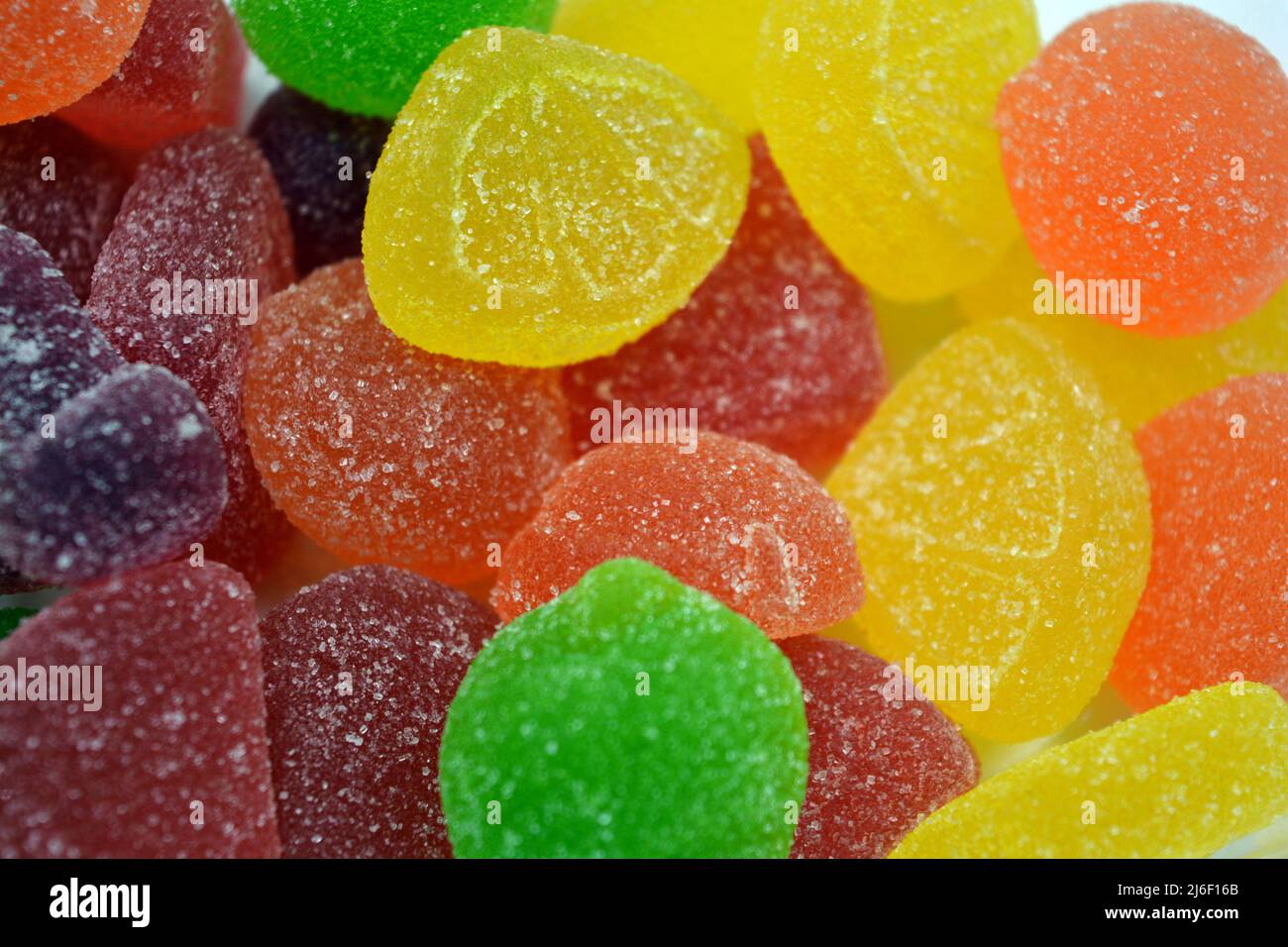Multi-colored sweets in the form of fruits of different colors: red ...