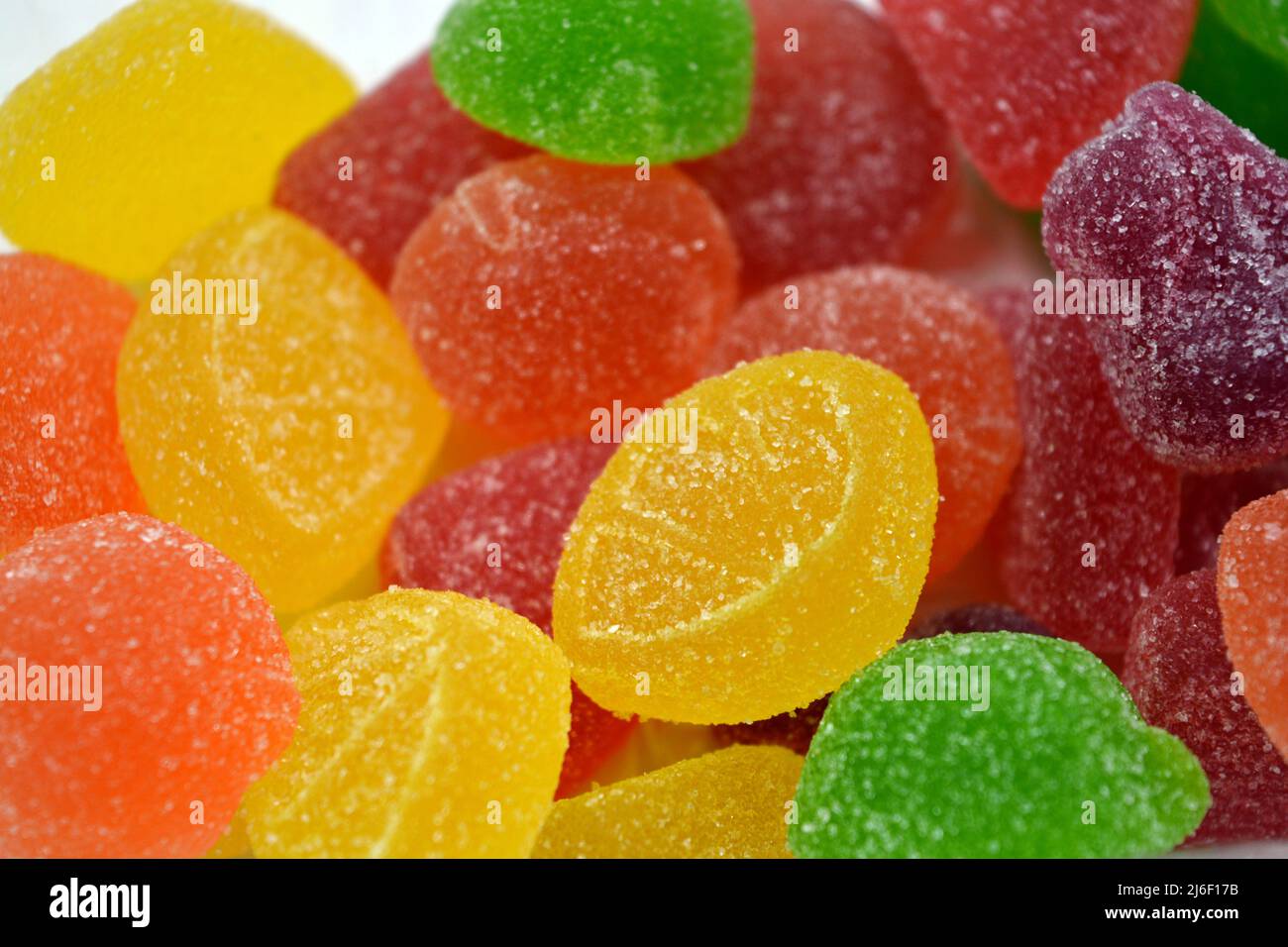 Multi-colored sweets in the form of fruits of different colors: red ...