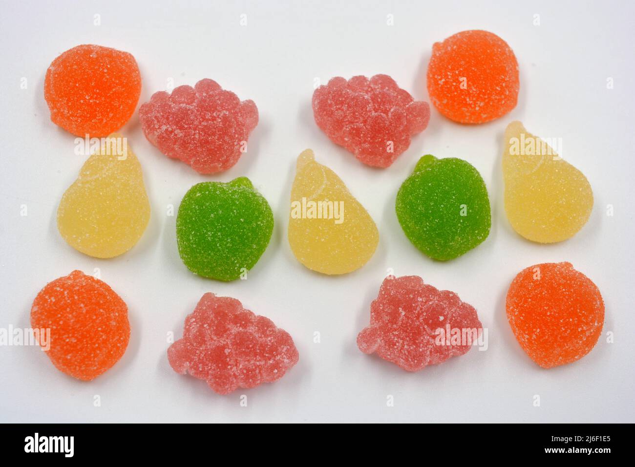 Multi-colored sweets in the form of fruits of different colors: red ...