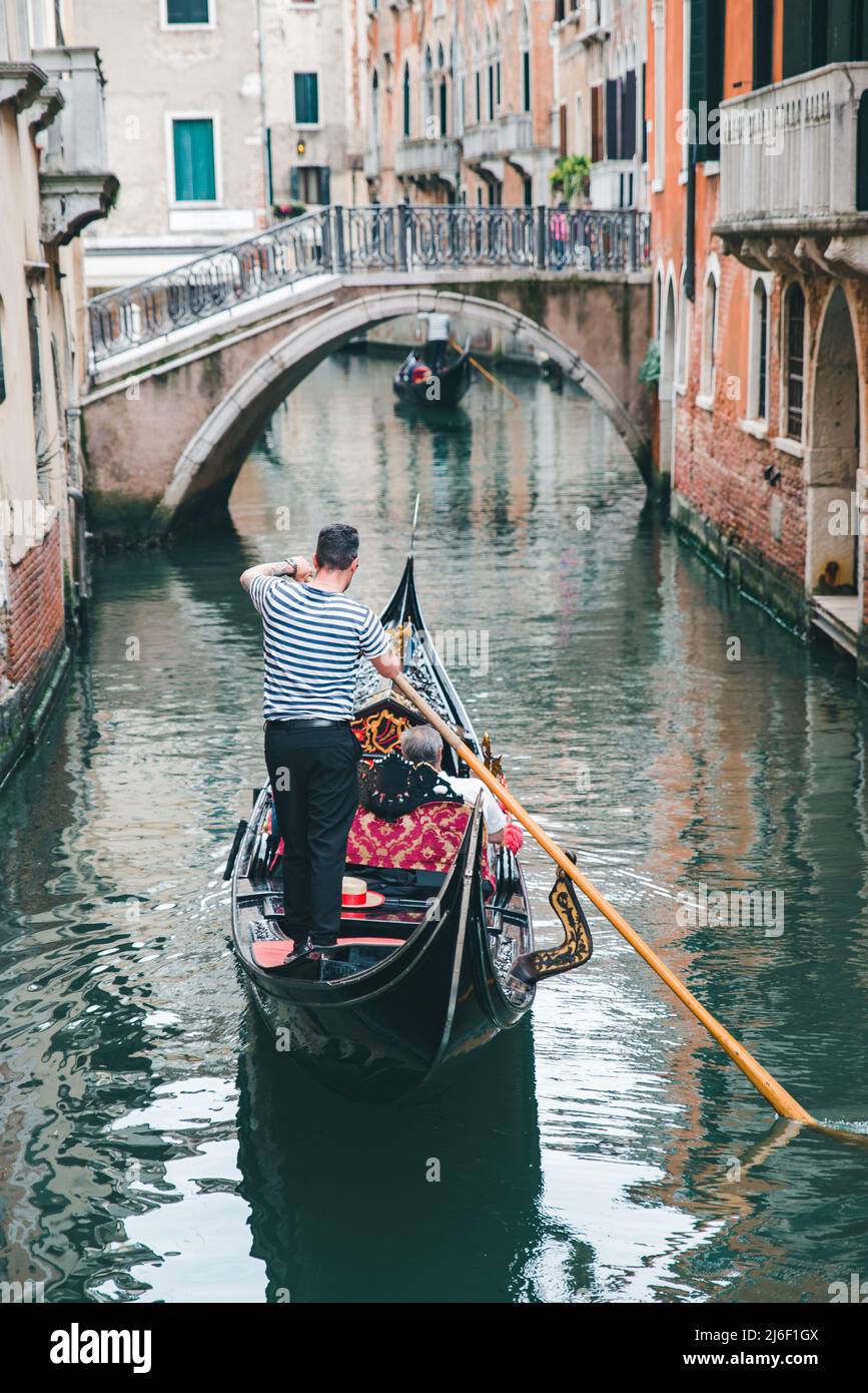 Venice, Italy - May 25, 2019: view of gondolas traffic in canal singer ...