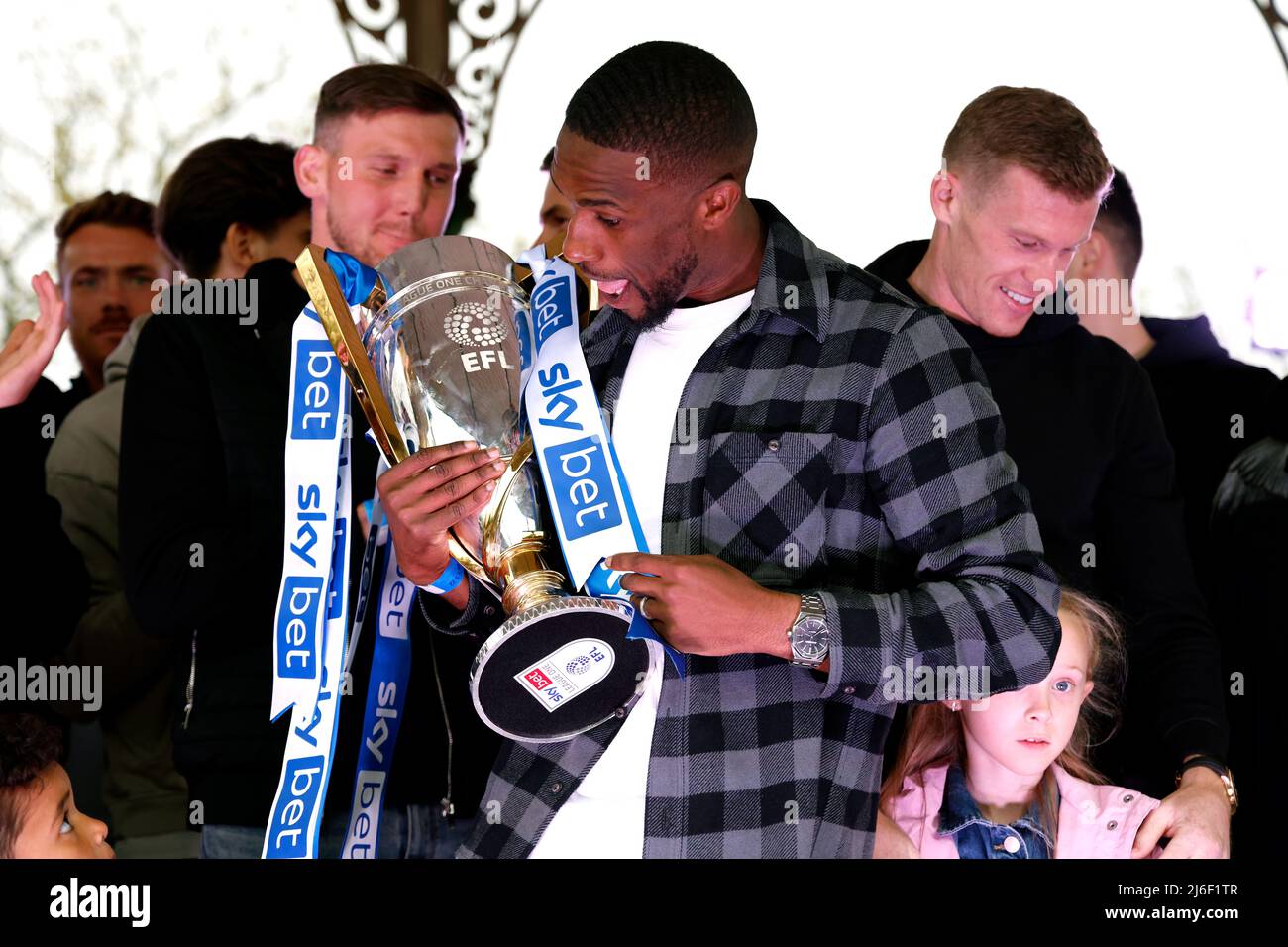 Wigan Athletic captain Tendayi Darikwa (centre) lifts the League One ...