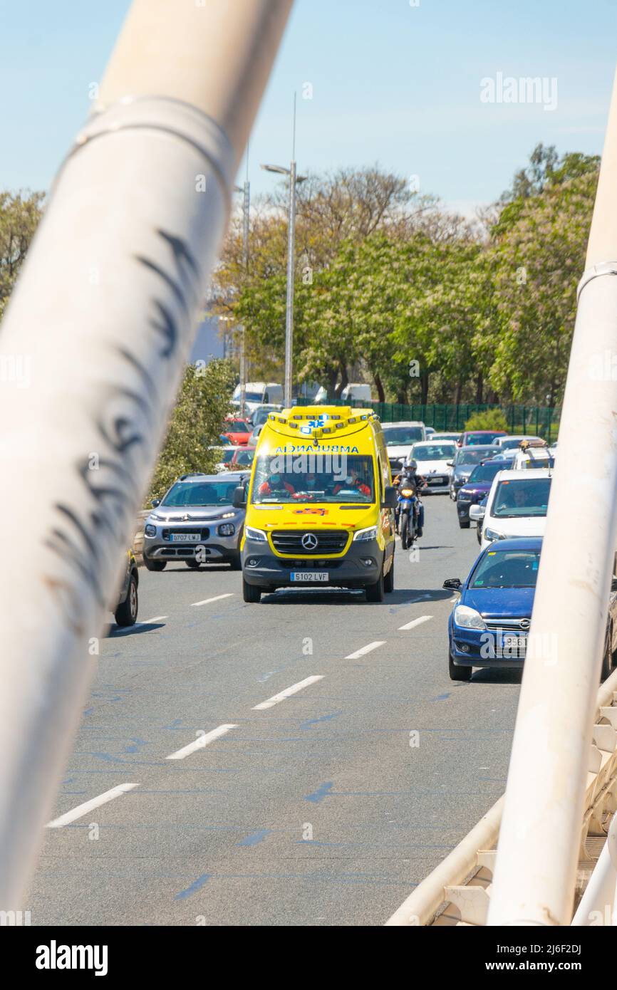 ambulance in traffic on Alamillo bridge over canal Sevilla-Bonanza in ...