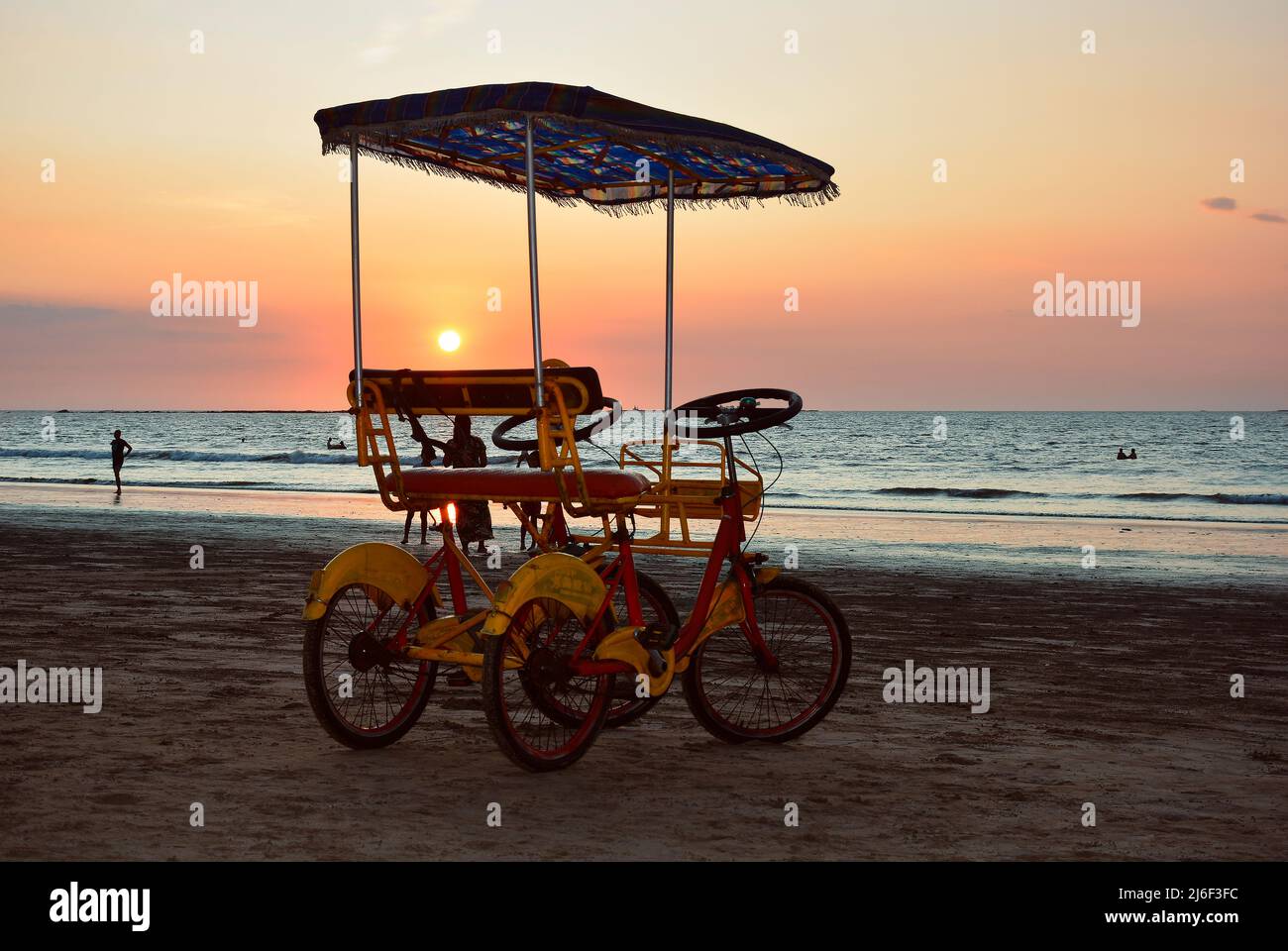 two persons bicycle on Chaung Thar beach during Sunset, Myanmar Stock ...