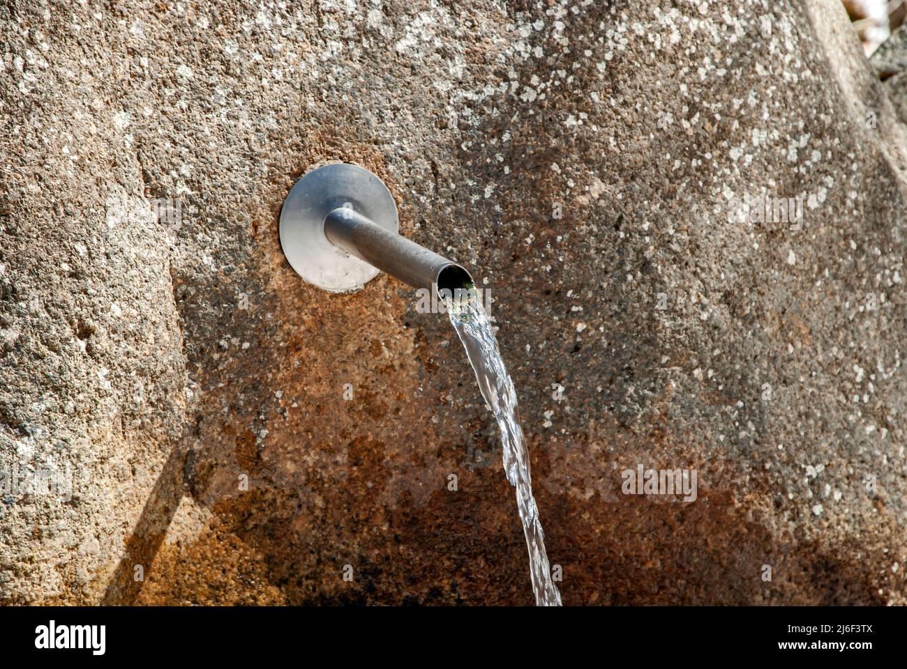 Stone mountain fountain with clear pure water running coming from ...