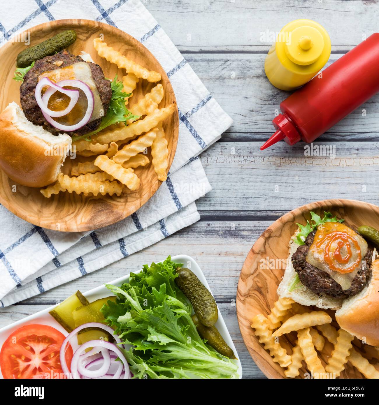 Cheeseburger sliders with fries and a platter of toppings Stock Photo ...