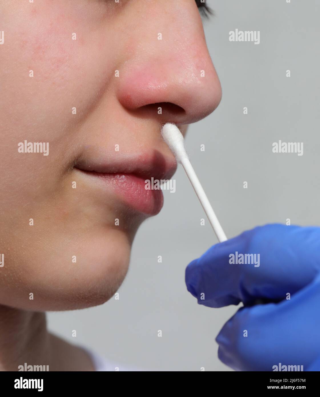 girl while a nasal swab test for Covid-19 virus is performed by a ...