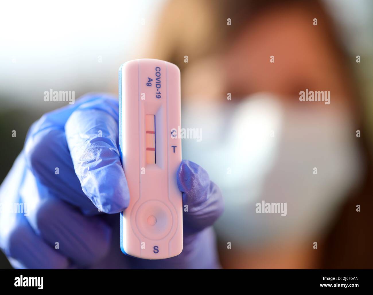 positive result of the swab for covid with the two lines and the hand ...