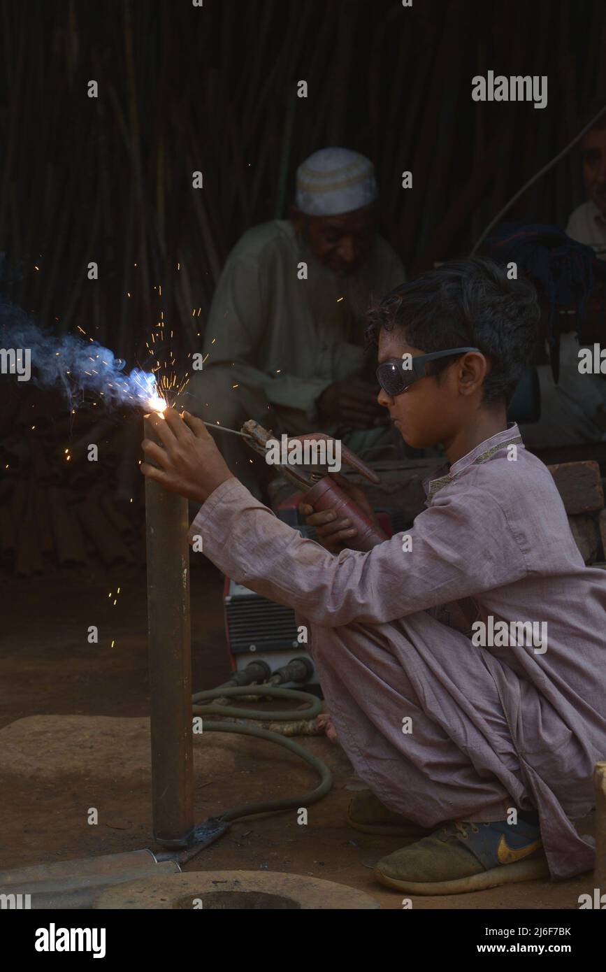 Pakistani laborers are busy in routine work at their workspace during ...