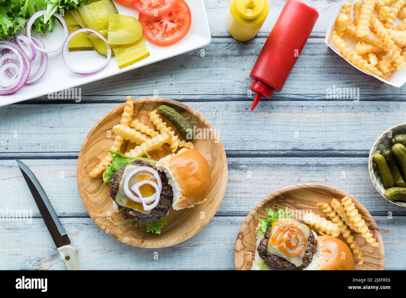 Cheeseburger sliders with fries and a platter of toppings Stock Photo ...