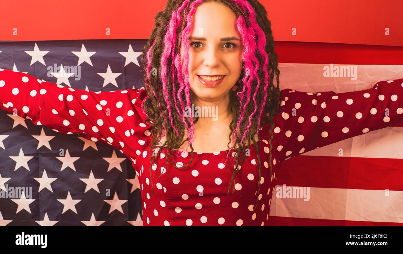 Young woman with American flag on red background. Happy female smiling ...