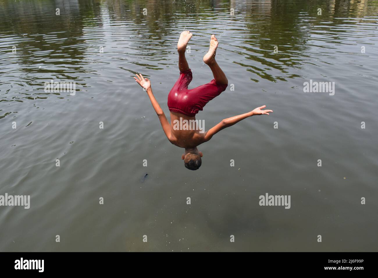 Boy jumps into pond hi-res stock photography and images - Alamy