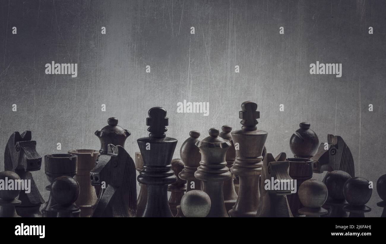 Mixed chess pieces in a group and grungy background Stock Photo - Alamy