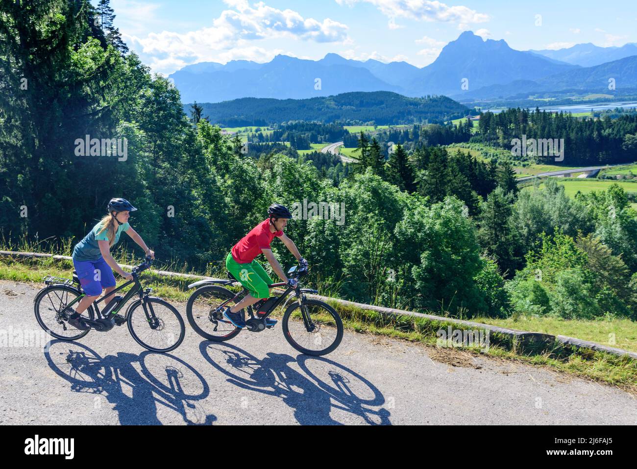 People cycling very easy and relaxed in the mountains with an electric ...