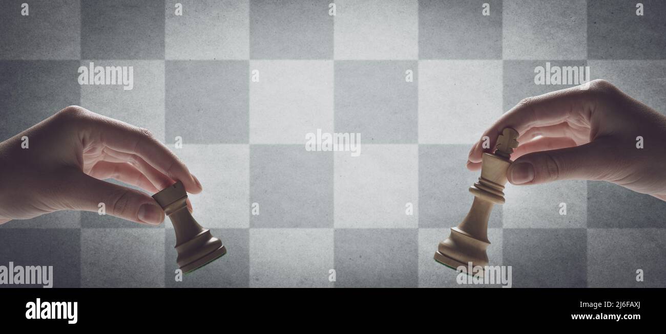 Chess players holding pieces and attacking each other, chessboard in ...