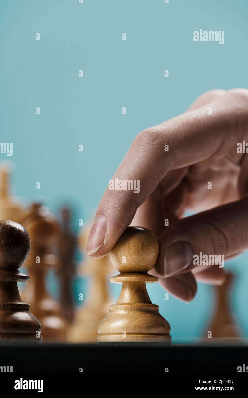 Professional player moving a pawn on the chessboard, chess game and ...