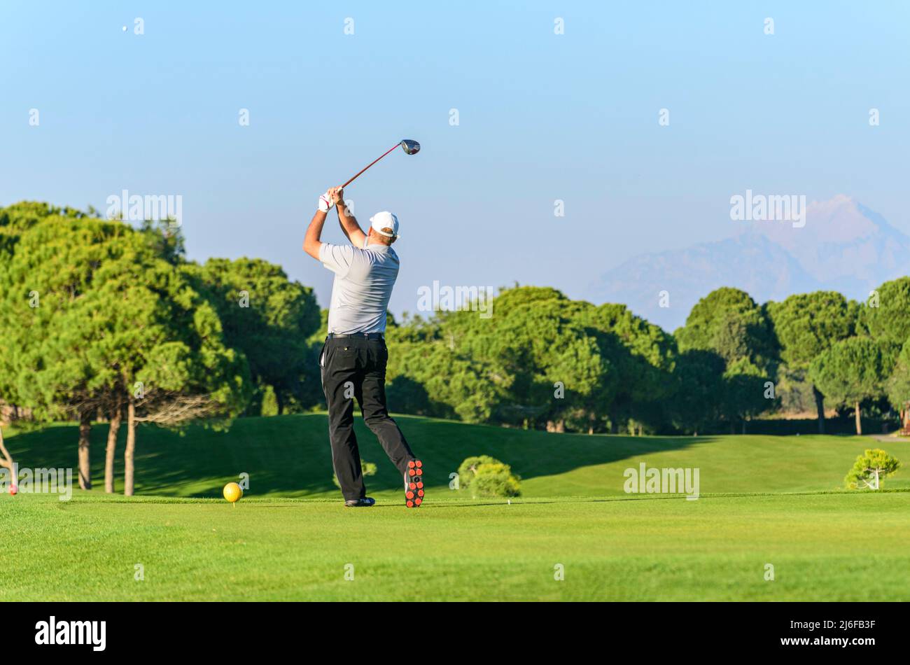Golfer swinging on golf course hi-res stock photography and images - Alamy
